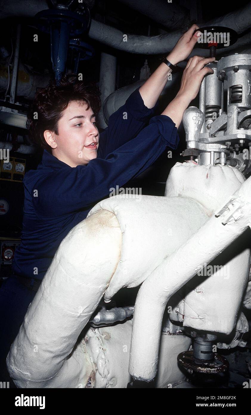 Boilerman Technician/Fireman Deanna Olivas opens a valve in the boiler ...