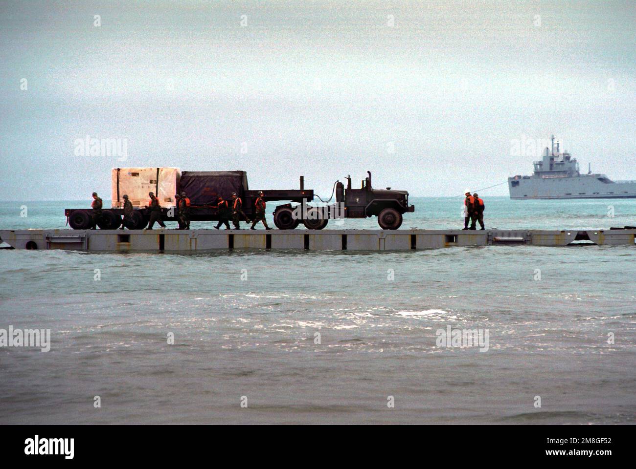 An M-52 5-ton tractor truck and a heavy equipment transporter semi ...