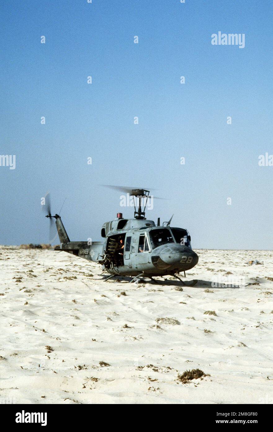 A UH-1N Iroquois helicopter of the U.S. Marine Corps lands on a beach ...