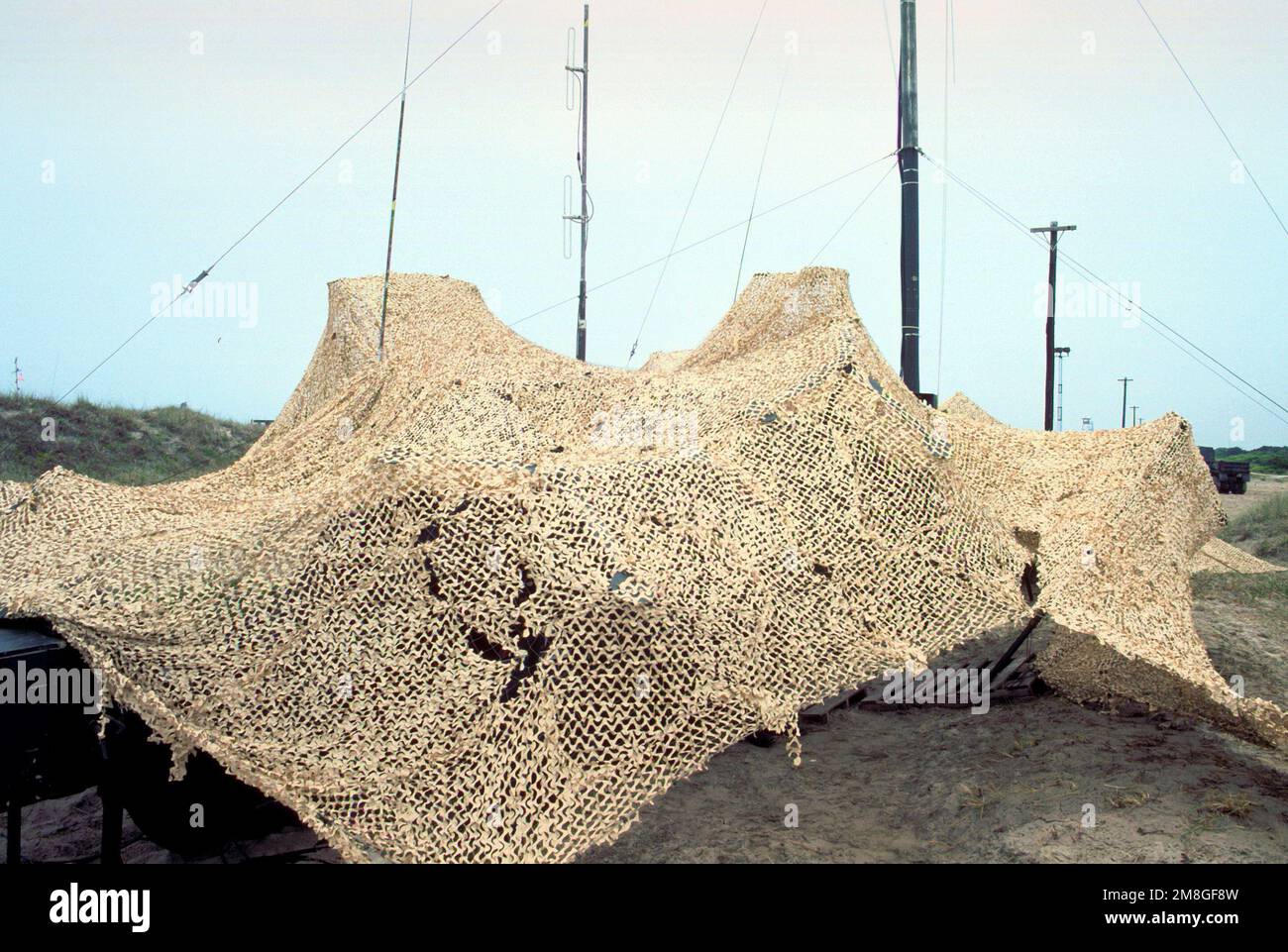 Camouflage nets cover vehicles and equipment of Mobile Inshore Undersea ...