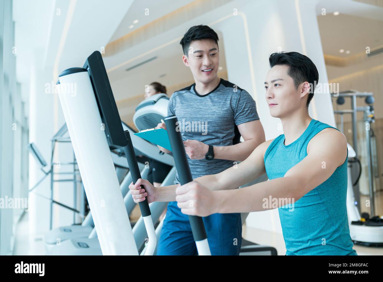 A young man in the private teaching under the guidance of fitness Stock ...
