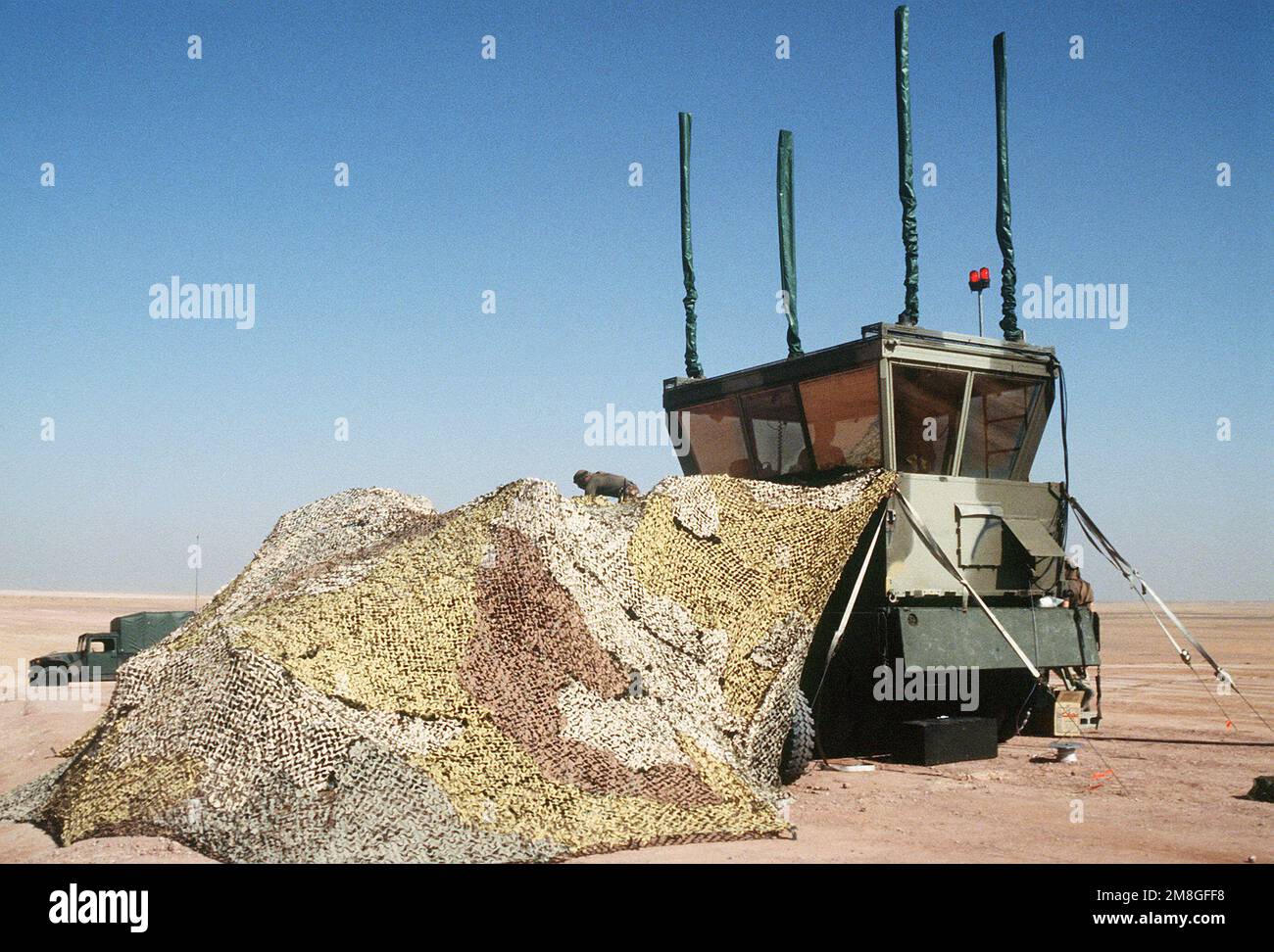 An air control tower, camouflaged with netting, completed by the 240th ...