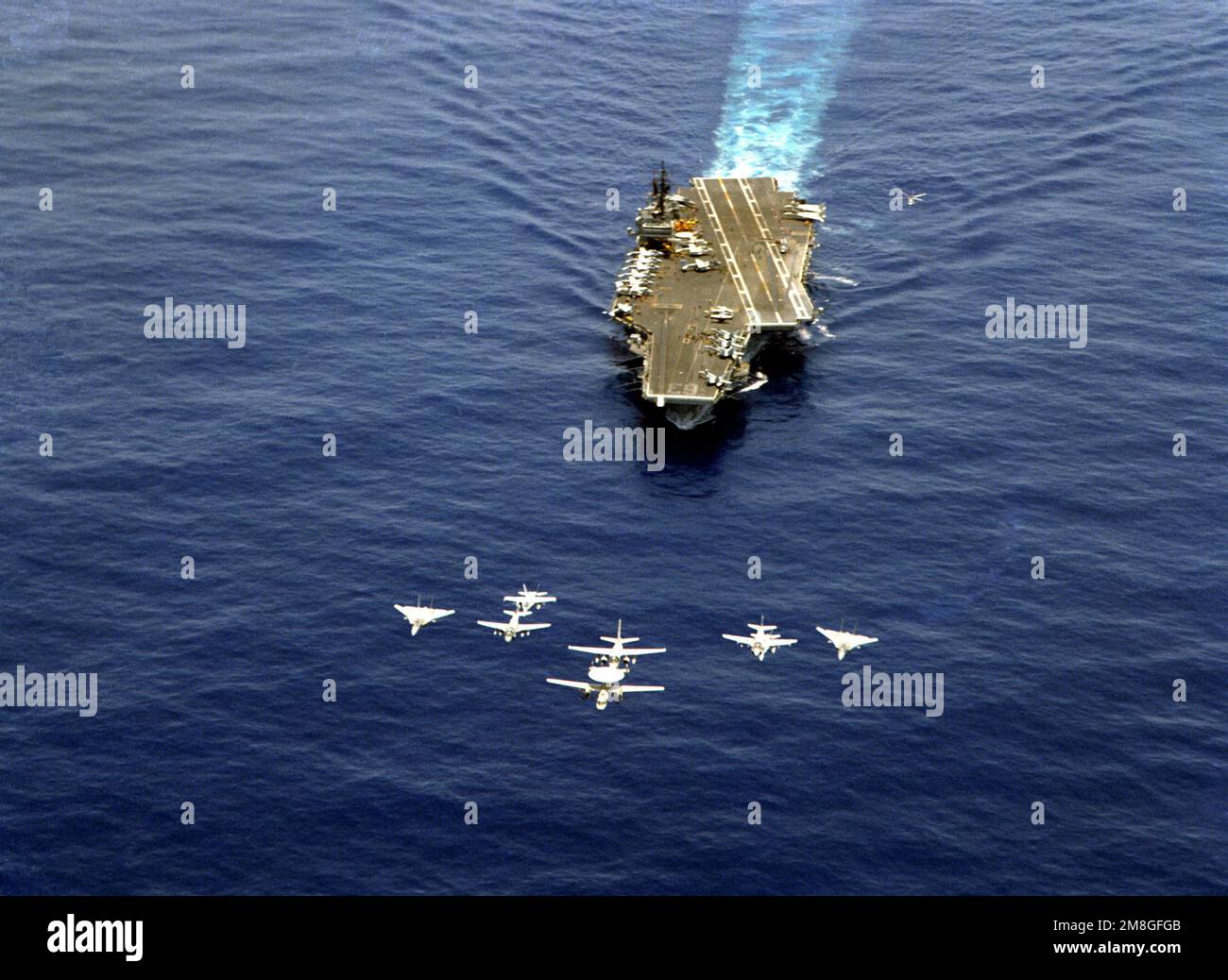 A bow view of the aircraft carrier USS KITTY HAWK (CV-63) underway with ...