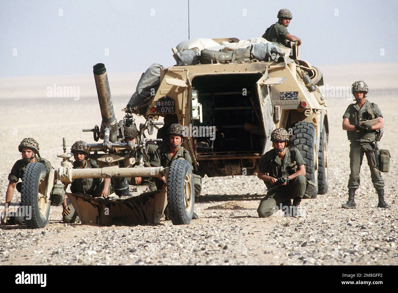 French soldiers prepare to fire a 120mm MO-120-RT-61 rifled mortar as it stands in position ...