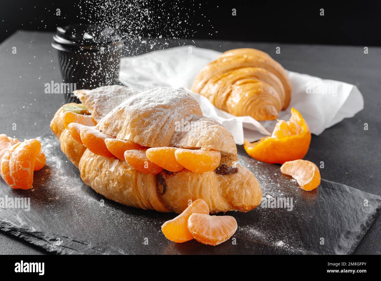 croissant with mandarins sweet on a dark background. Homemade ...