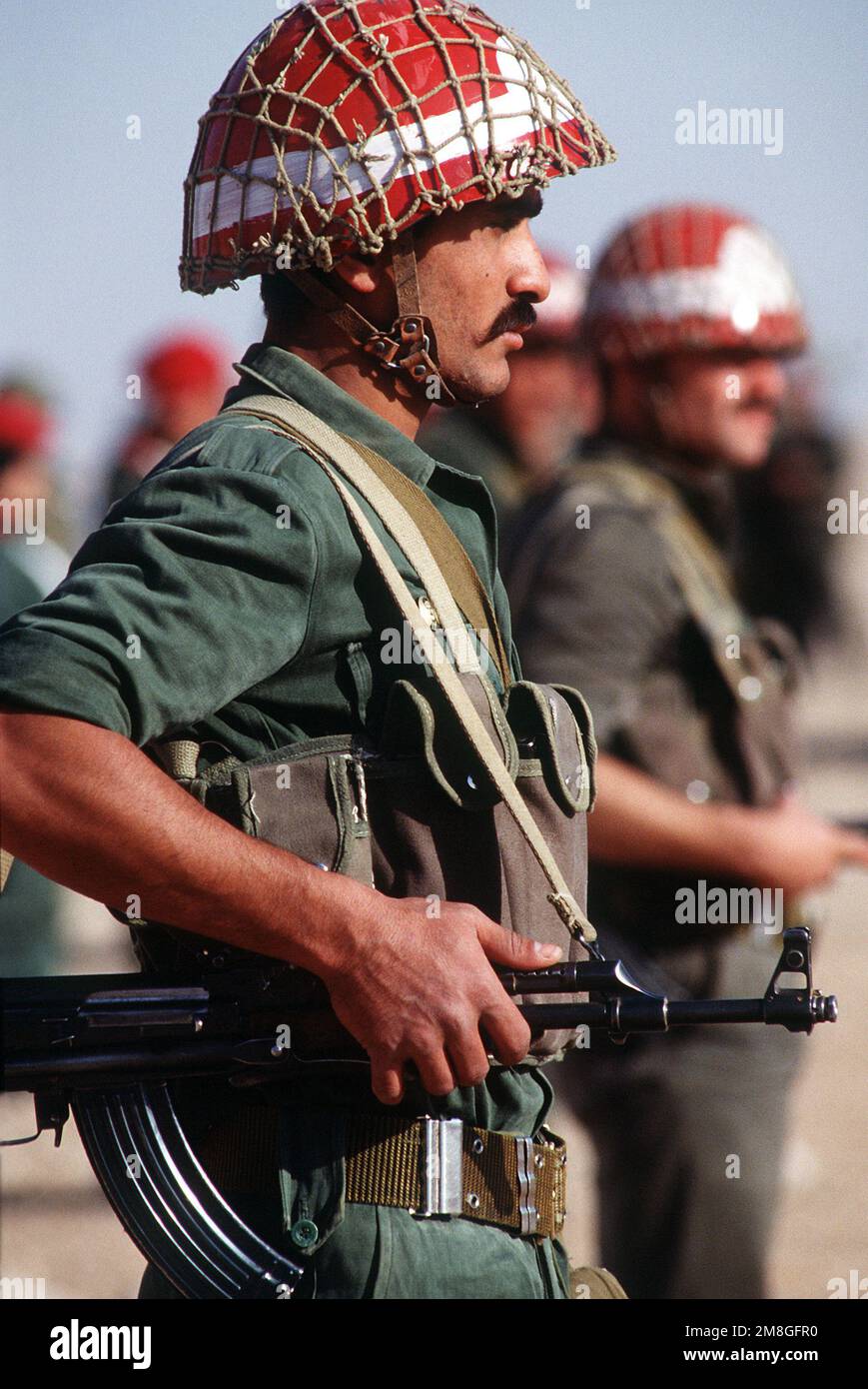 A member of a Syrian honor guard stands at attention as his unit ...