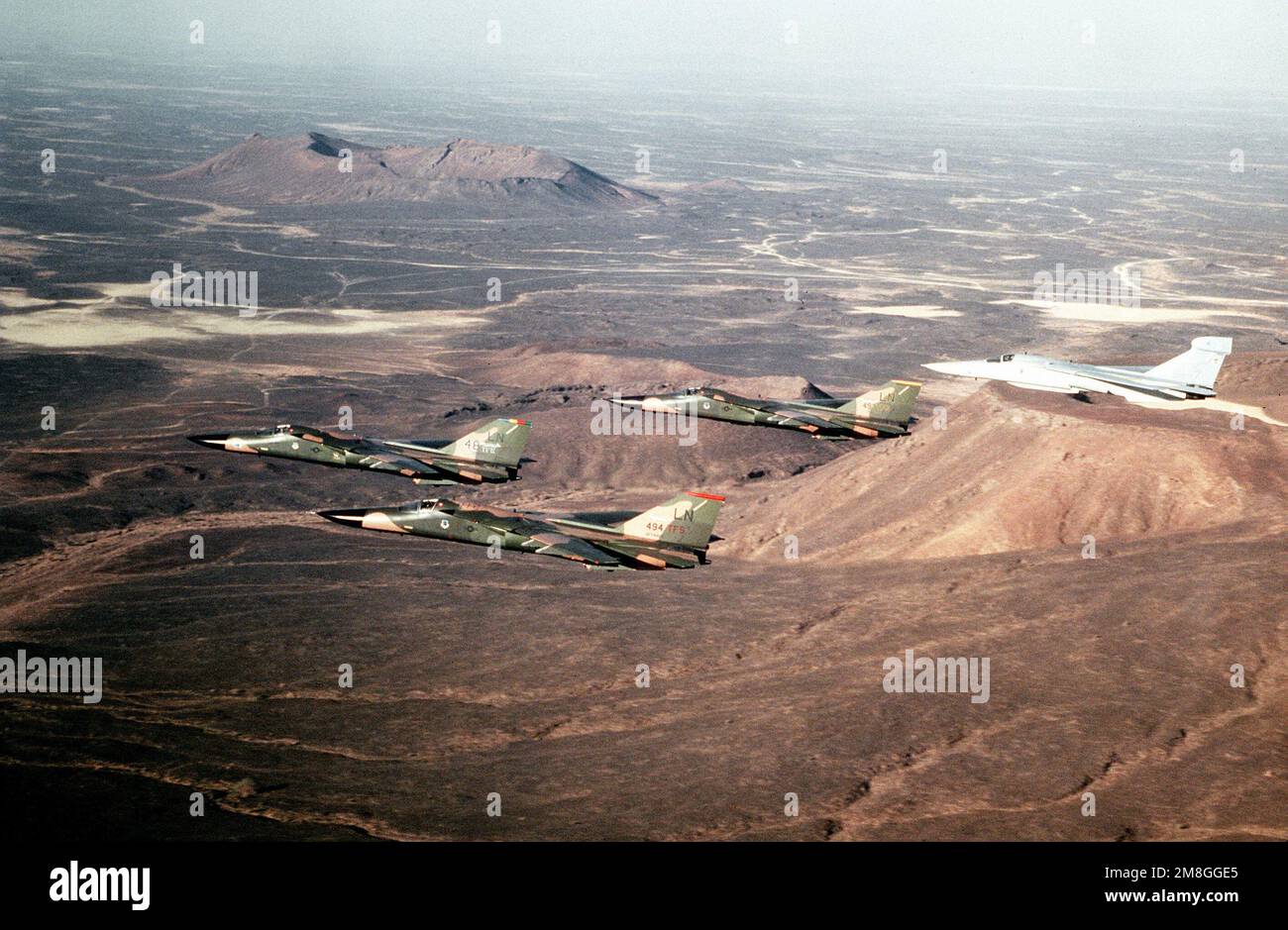 F-111F aircraft and an EF-111A Raven aircraft, rear, fly in formation ...