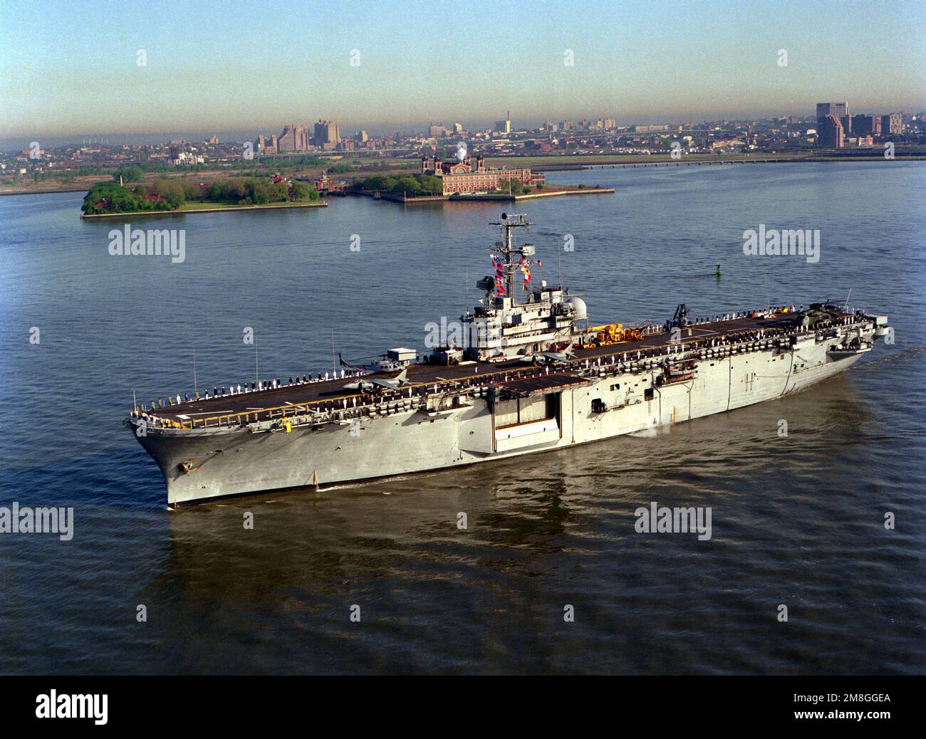 A port side view of the amphibious ship USS GUADALCANAL (LPH-7) passing ...