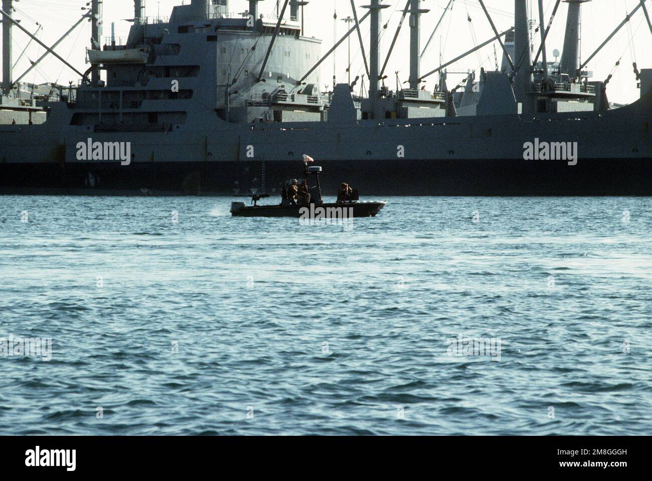 Members of a U.S. Coast Guard security unit patrol the water in a ...