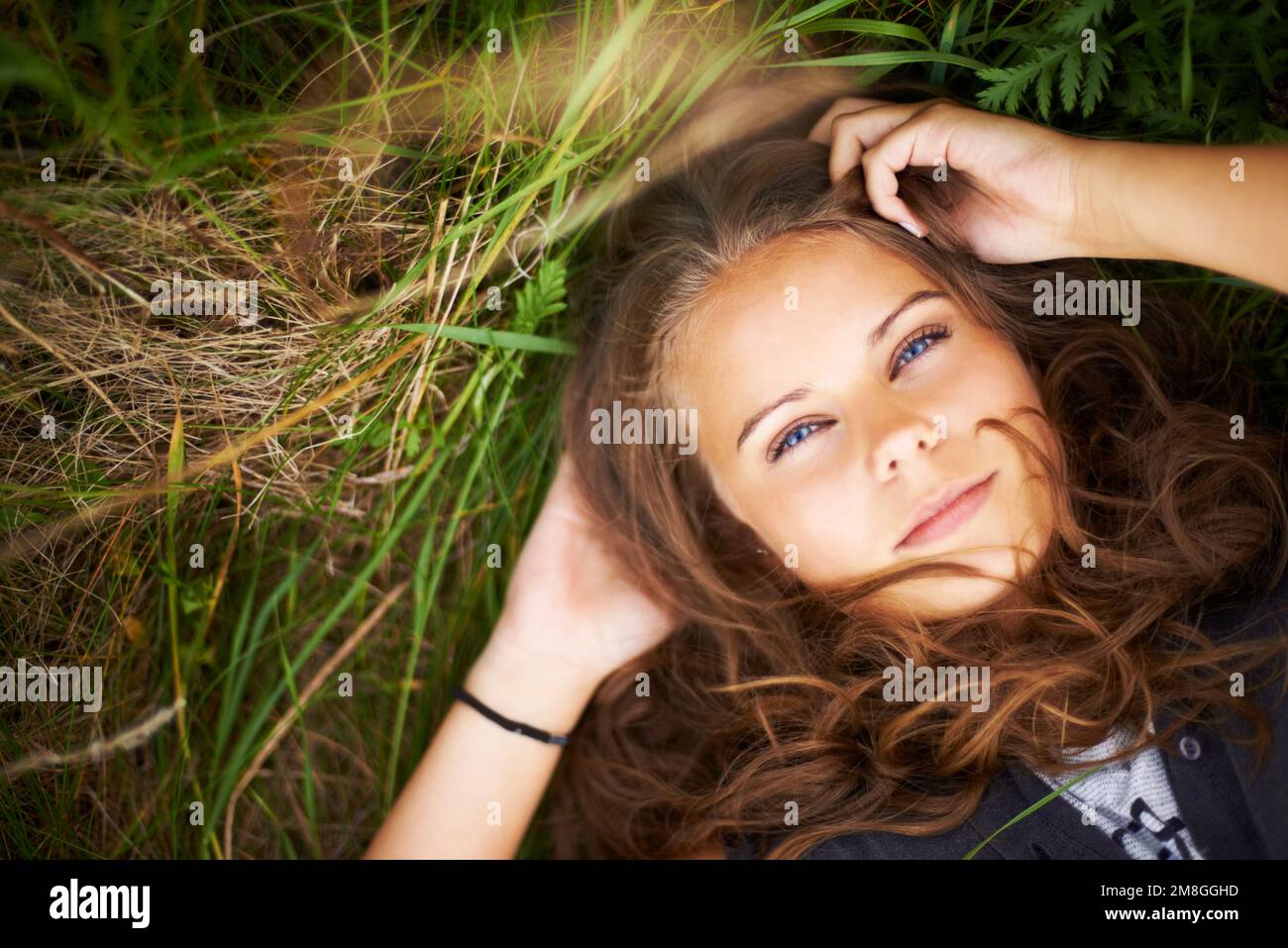 Natural copyspace. Portrait of a beautiful womanl lying on her back ...