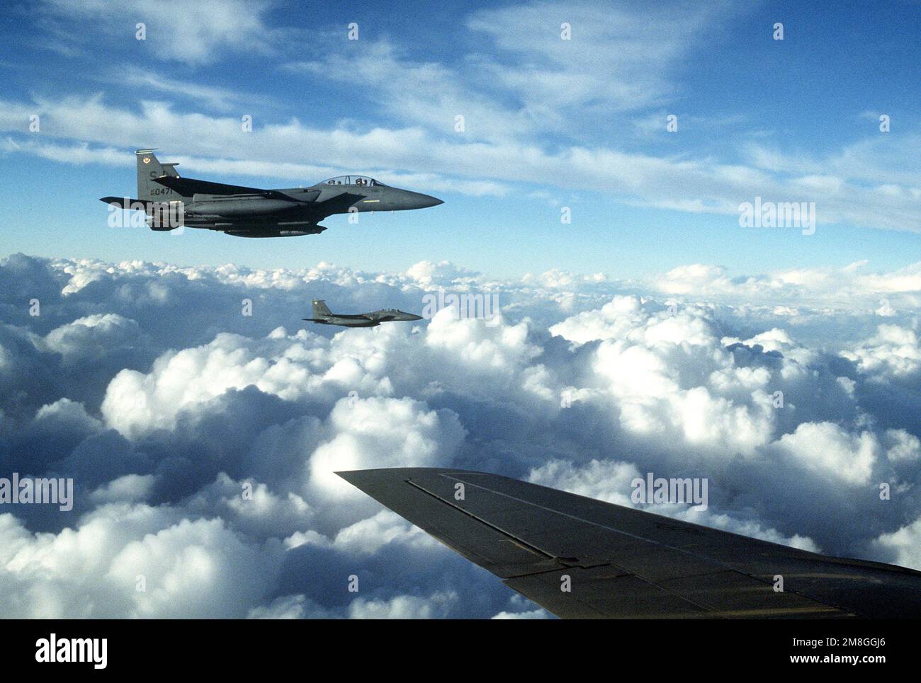 F-15E Eagle aircraft of the 4th Tactical Fighter Wing fly near a KC ...