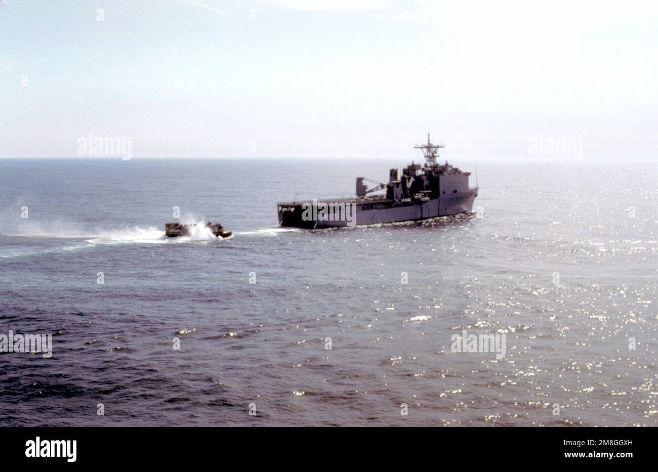 An air-cushion landing craft (LCAC) disembarks from the well deck of ...