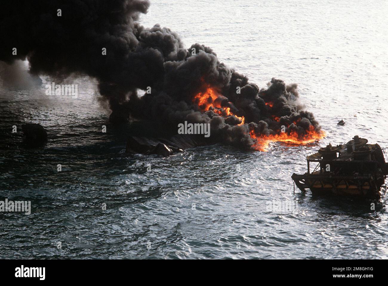 Black smoke pours from burning oil at an offshore oil terminal near ...