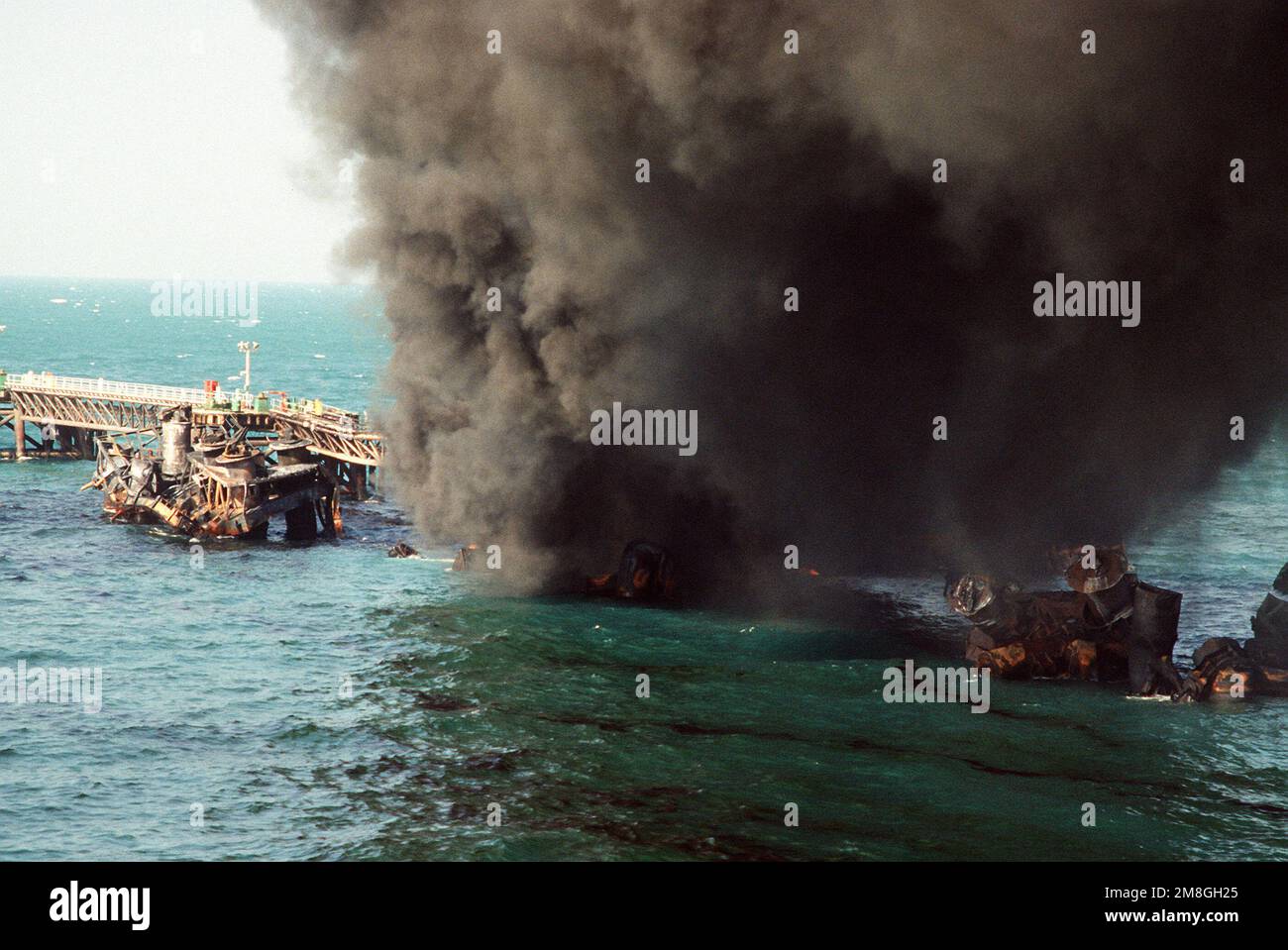 Black smoke pours from burning oil at an offshore oil terminal near ...