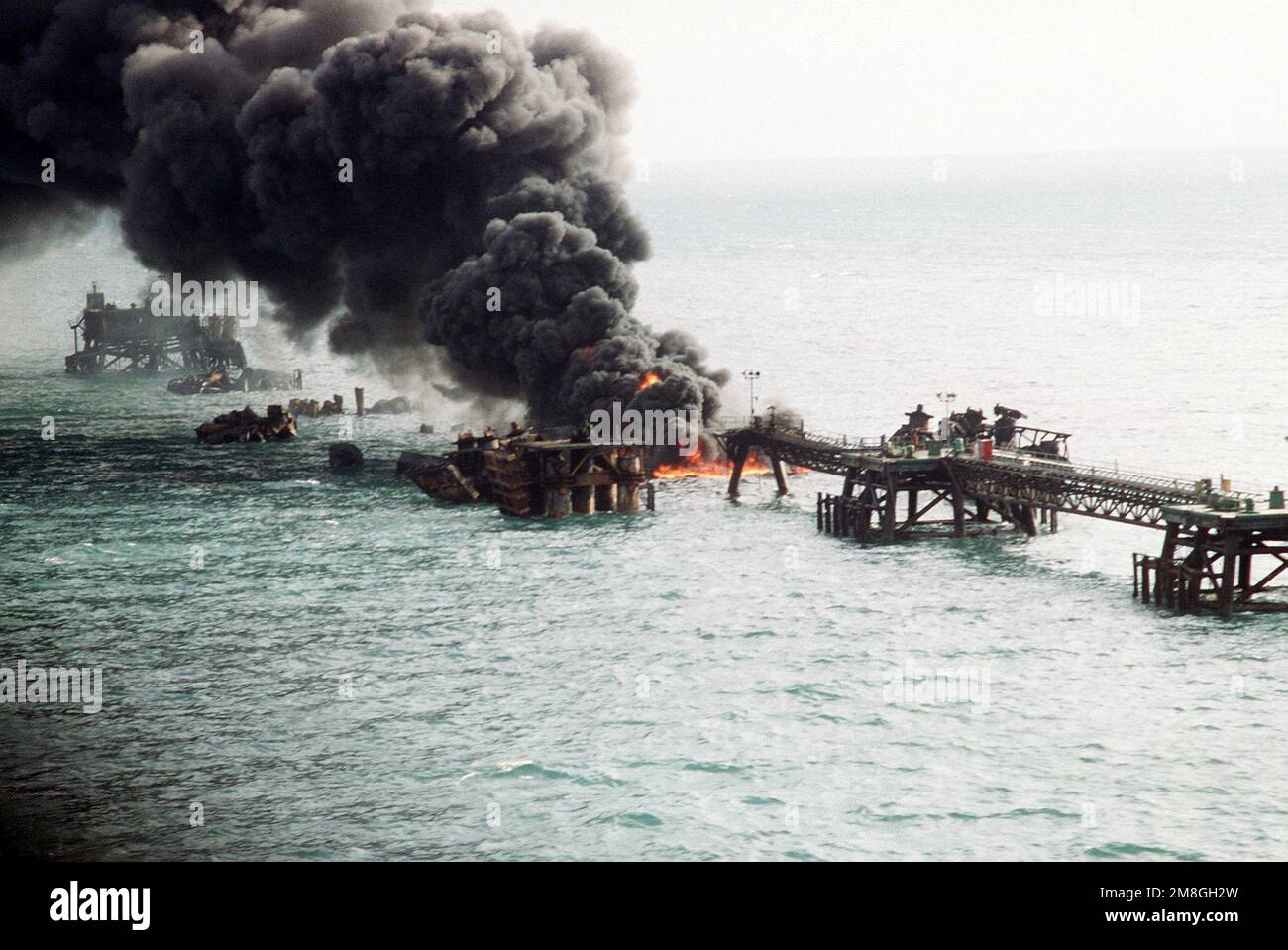 Black smoke pours from burning oil at an offshore oil terminal near ...