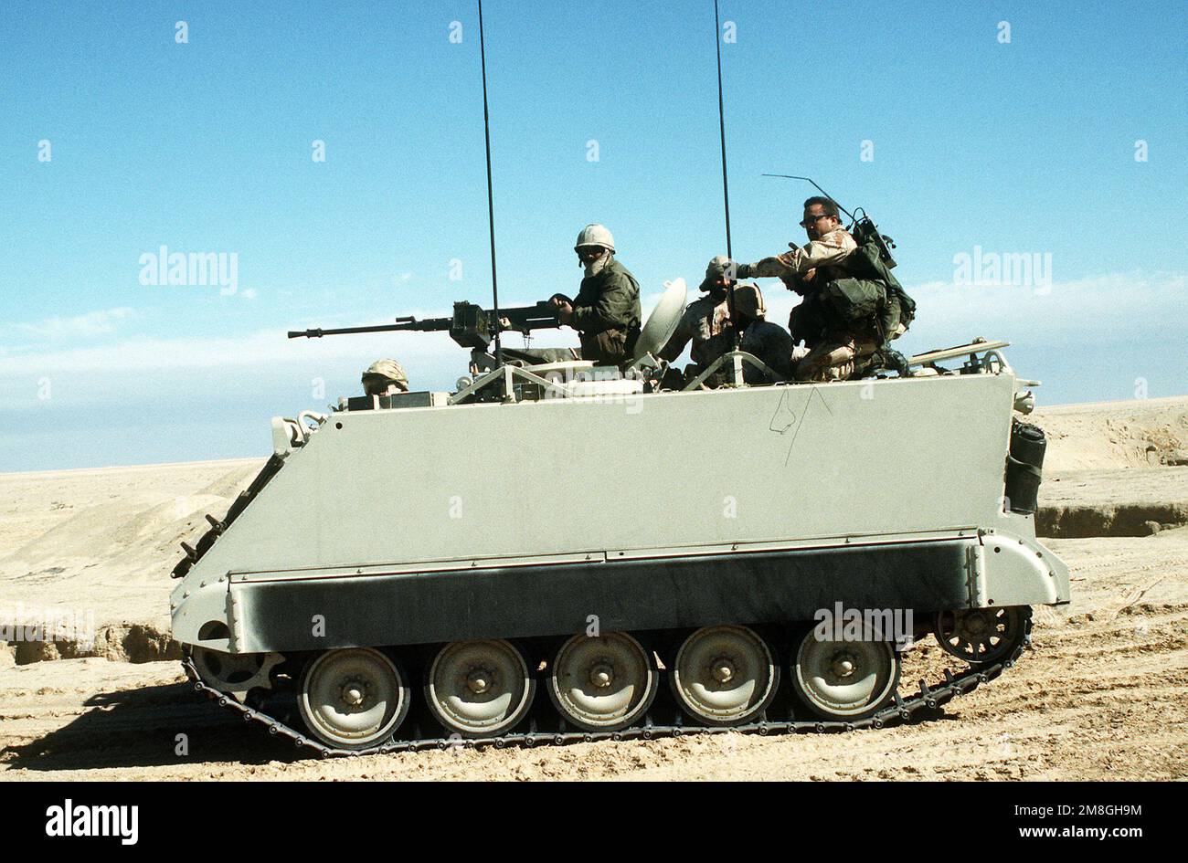 Military personnel are transported in an M-113 armored personnel ...