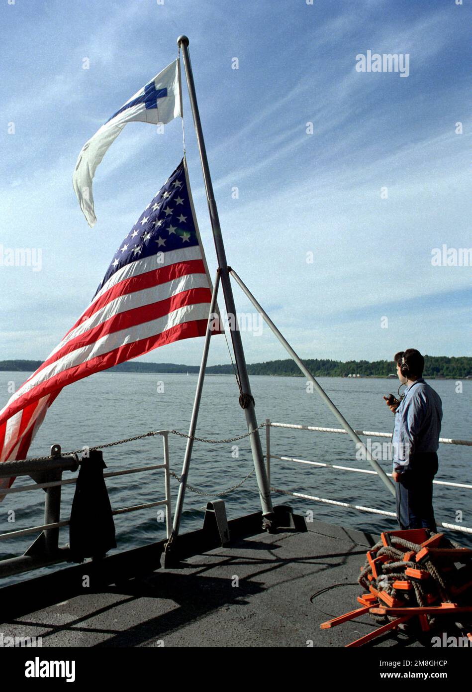 SEAMAN Cole talks on a sound-powered phone as he stands beside the ...