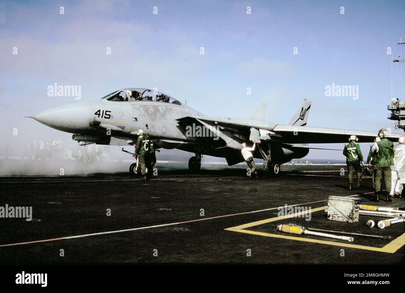 Flight deck personnel prepare an F-14A Tomcat aircraft of Fighter ...