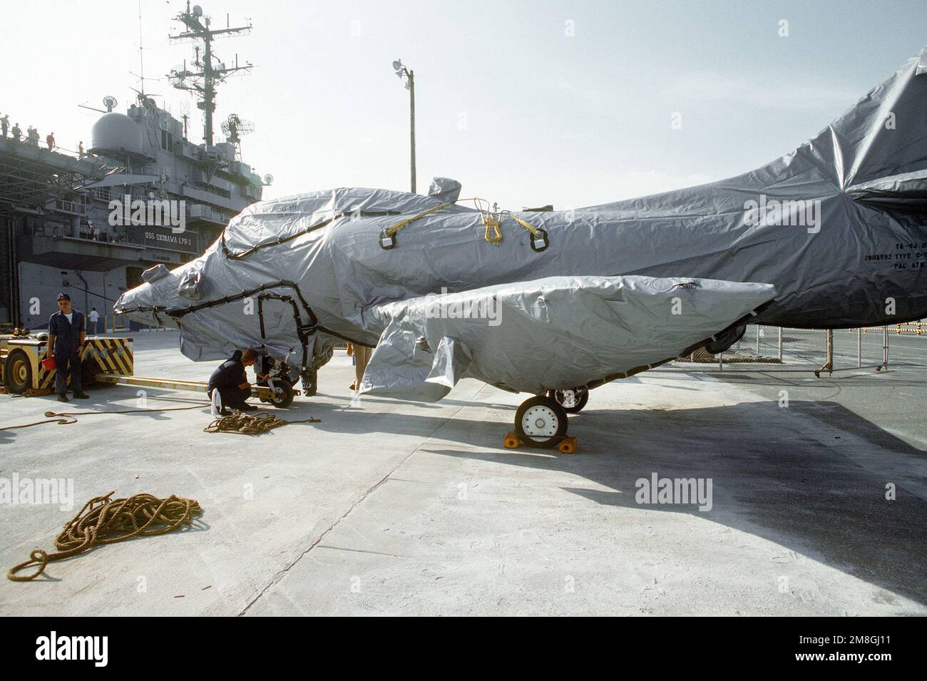 A TA-4J Skyhawk aircraft is wrapped in protective covering prior to ...