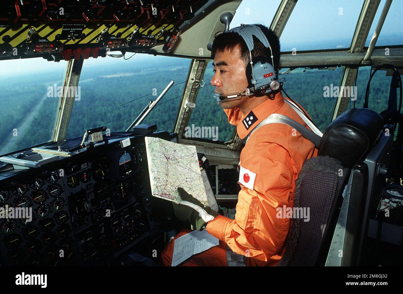 CAPT. K. Saiki, A C-130 copilot with the Japanese AIr Self Defense Force team, looks for ...