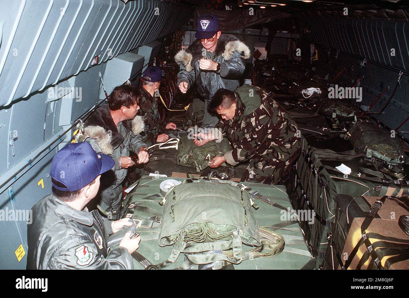 Crew members of a 63rd Air Wing C-141B Starlifter aircraft rig ...