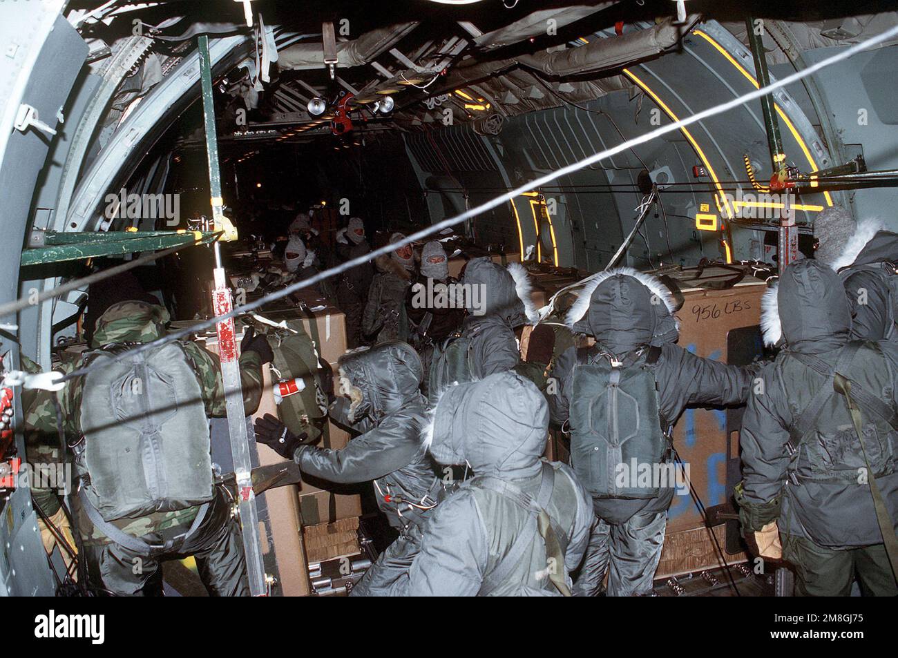 Crew members of a 63rd Air Wing C-141B Starlifter aircraft prepare to ...
