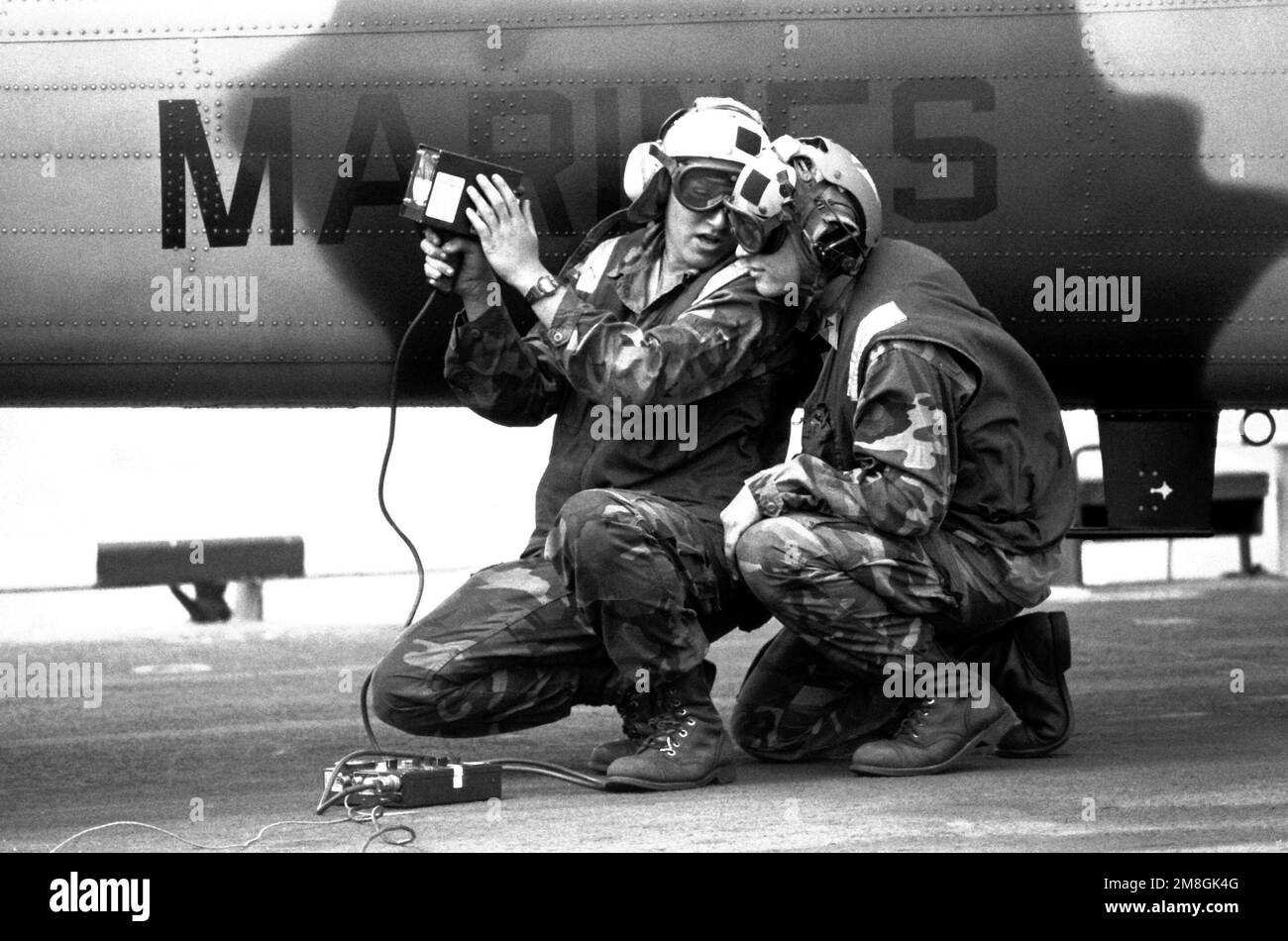 Marines check the alignment and synchronization of a helicopter's tail ...