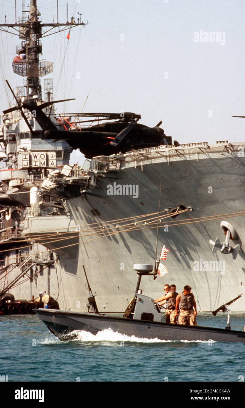 A U.S. Coast Guard Sea Raider harbor security boat passes the ...