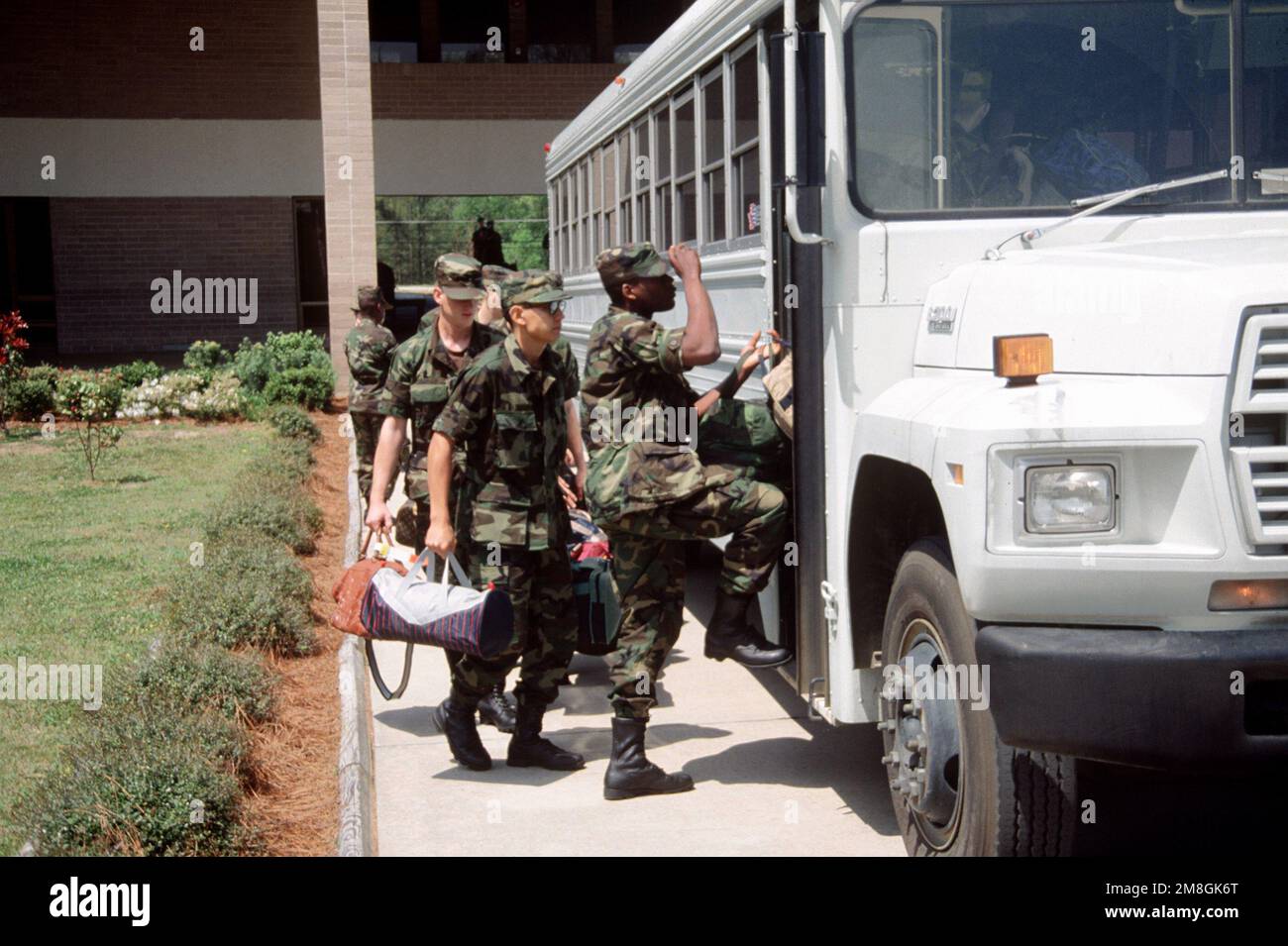 Soldiers board the bus that will take them to their basic training ...