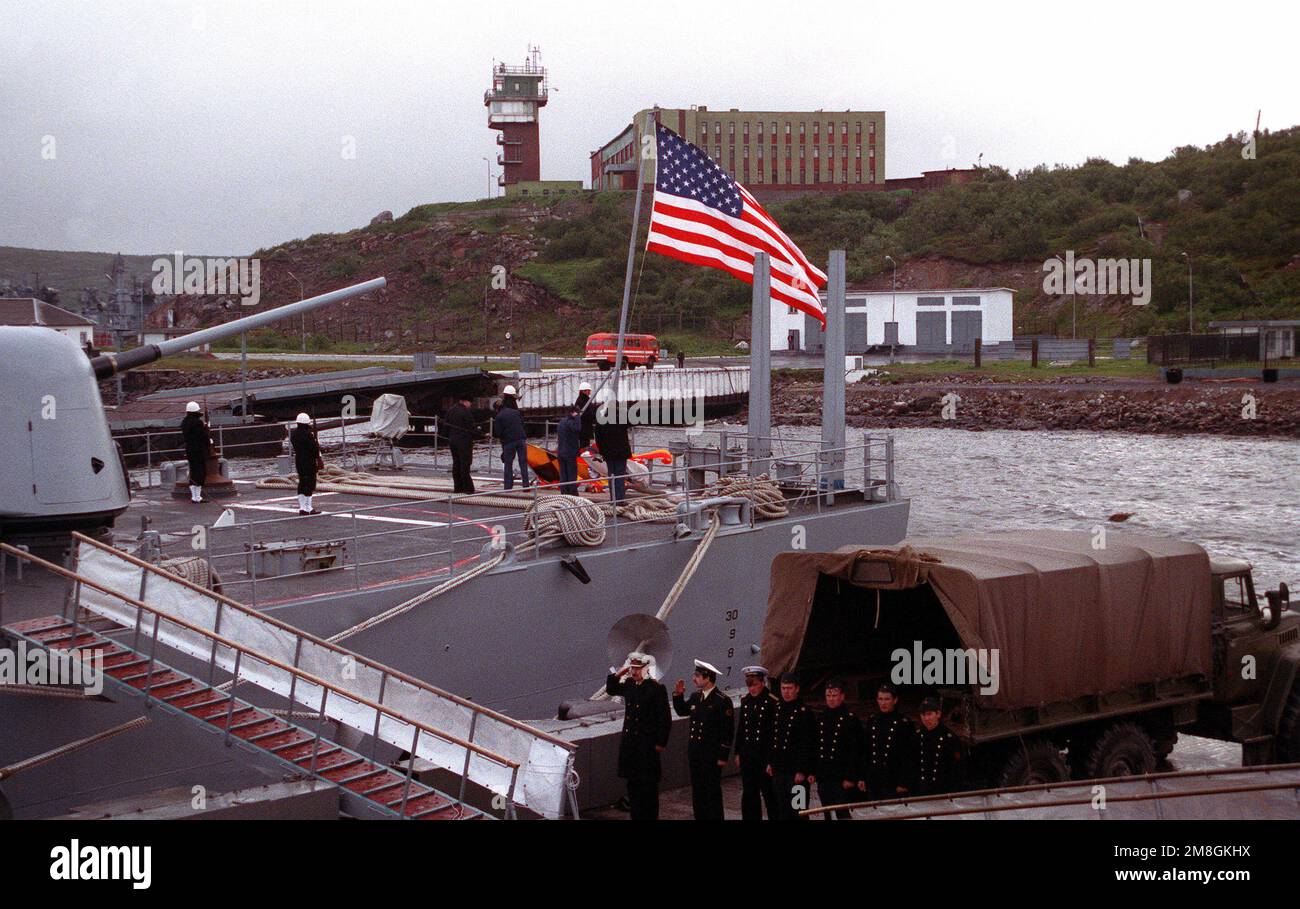 Russian sailors stand in formation on the pier as crew members raise ...