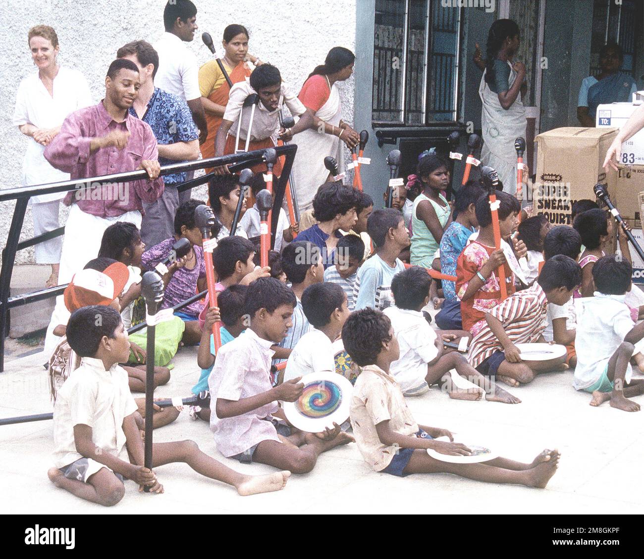 Children from the Mercy Homes Orphanage receive toys delivered by crew ...
