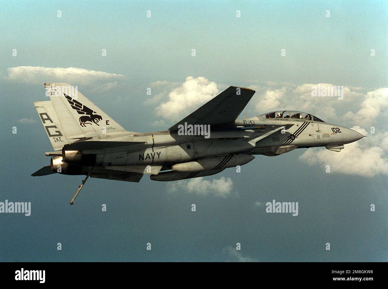 A Fighter Squadron 143 (VF-143) F-14B Tomcat aircraft banks to the left ...
