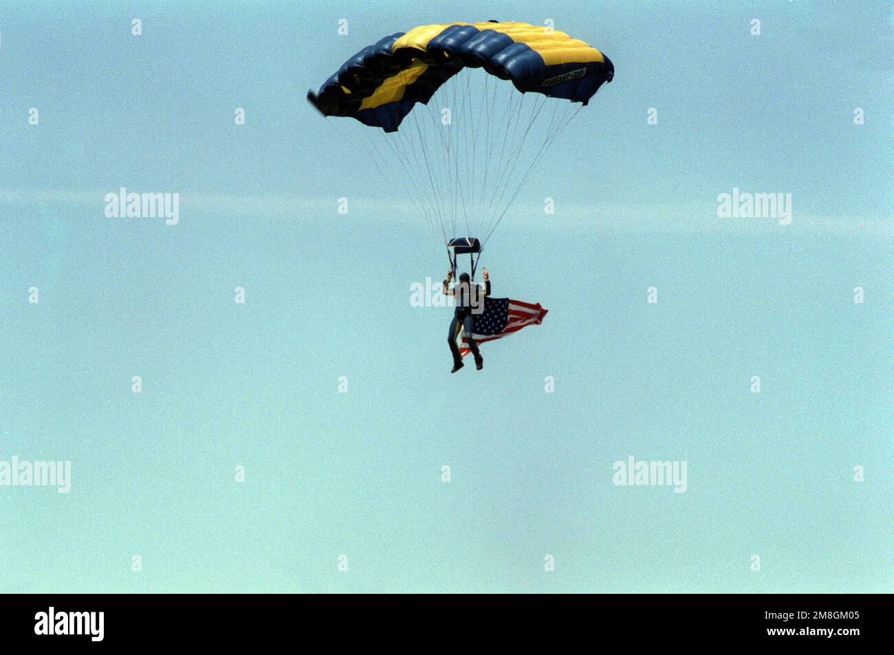 A member of the Leapfrogs, the U.S. Navy parachute team, displays the ...