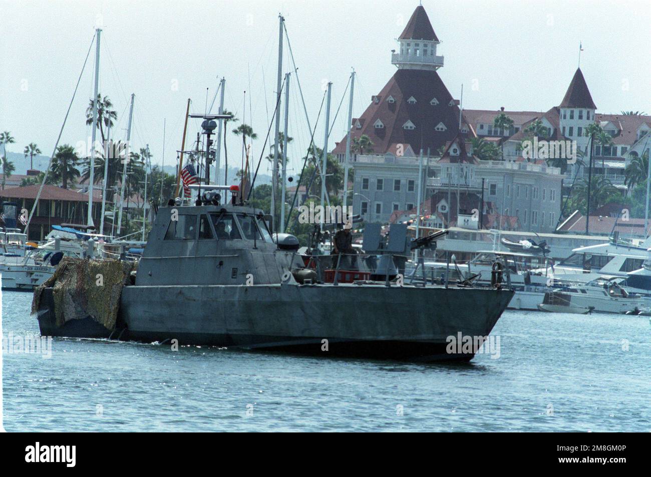 U.S. Navy personnel pilot a PB Mark III patrol boat through a harbor ...