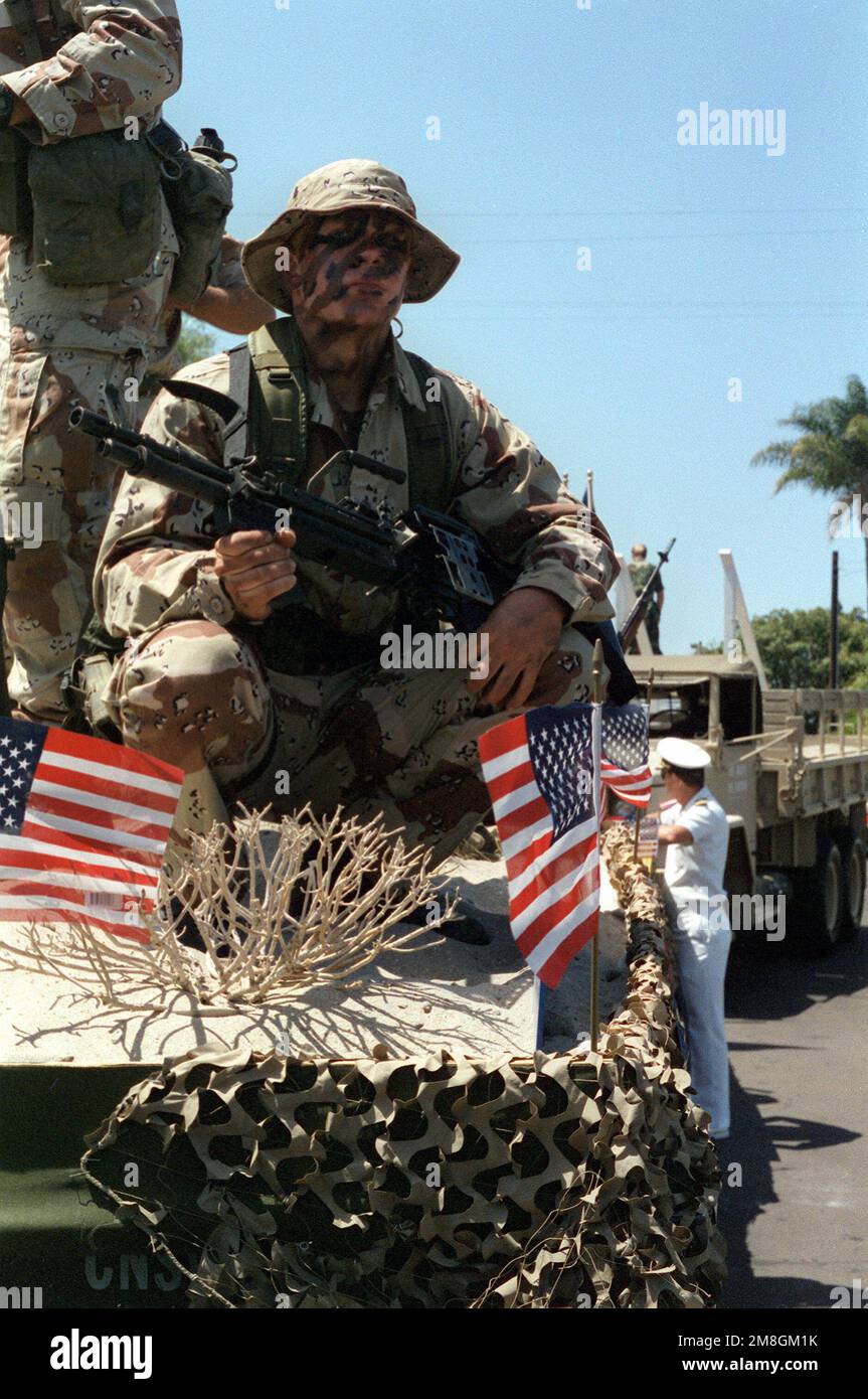 A member of a U.S. Navy Sea-Air-Land (SEAL) team maintains his position ...