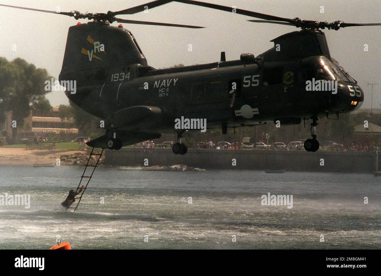 A member of a U.S. Navy Sea-Air-Land (SEAL) team grabs onto a rope ...