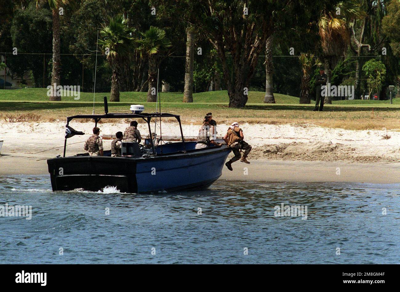 A member of a U.S. Navy Sea-Air-Land (SEAL) team jumps from a utility ...