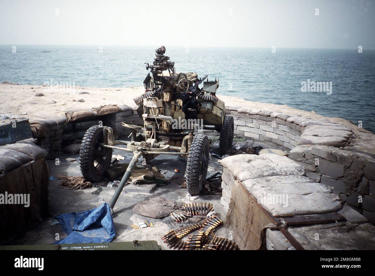 An abandoned Iraqi ZPU-4 anti-aircraft gun remains on the beach in ...