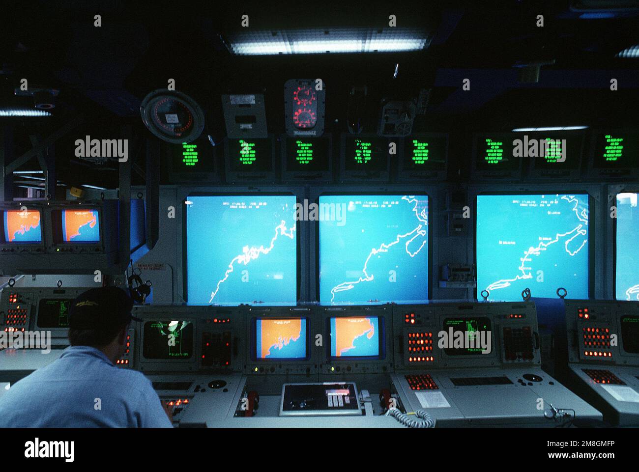 A sailor mans one of the control panels of the Combat Information ...
