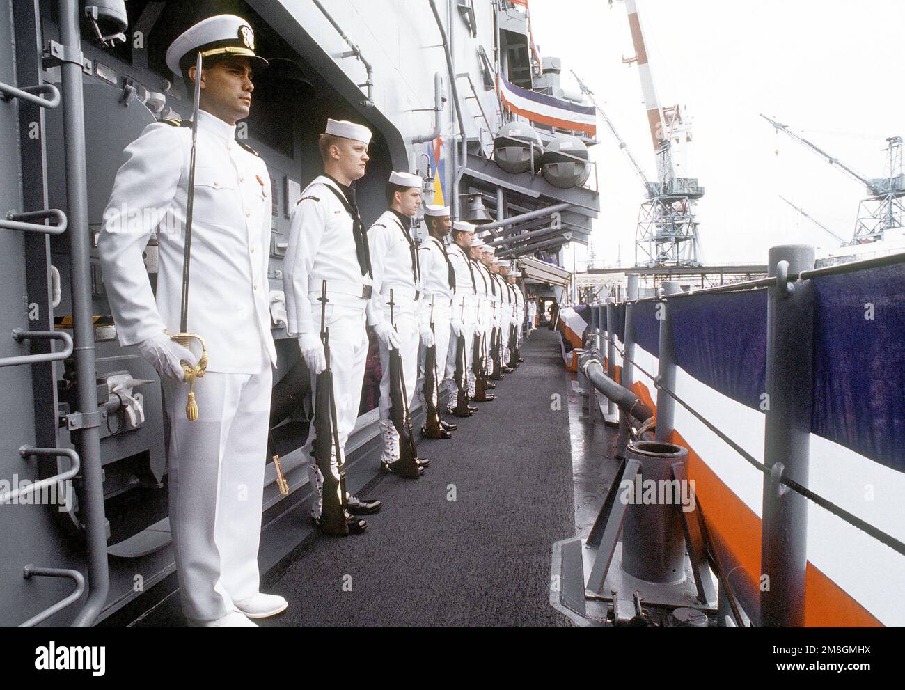 An honor guard stands at attention on the main deck of the guided ...