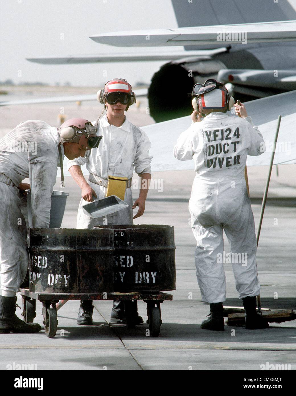 Ground crew members prepare to clean the air intake ducts of a Fighter ...