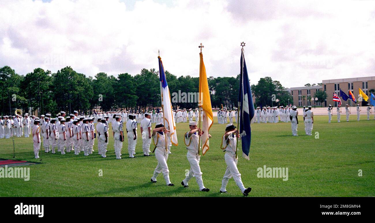 Flagbearers carry religious flags during the graduation ceremony of a ...