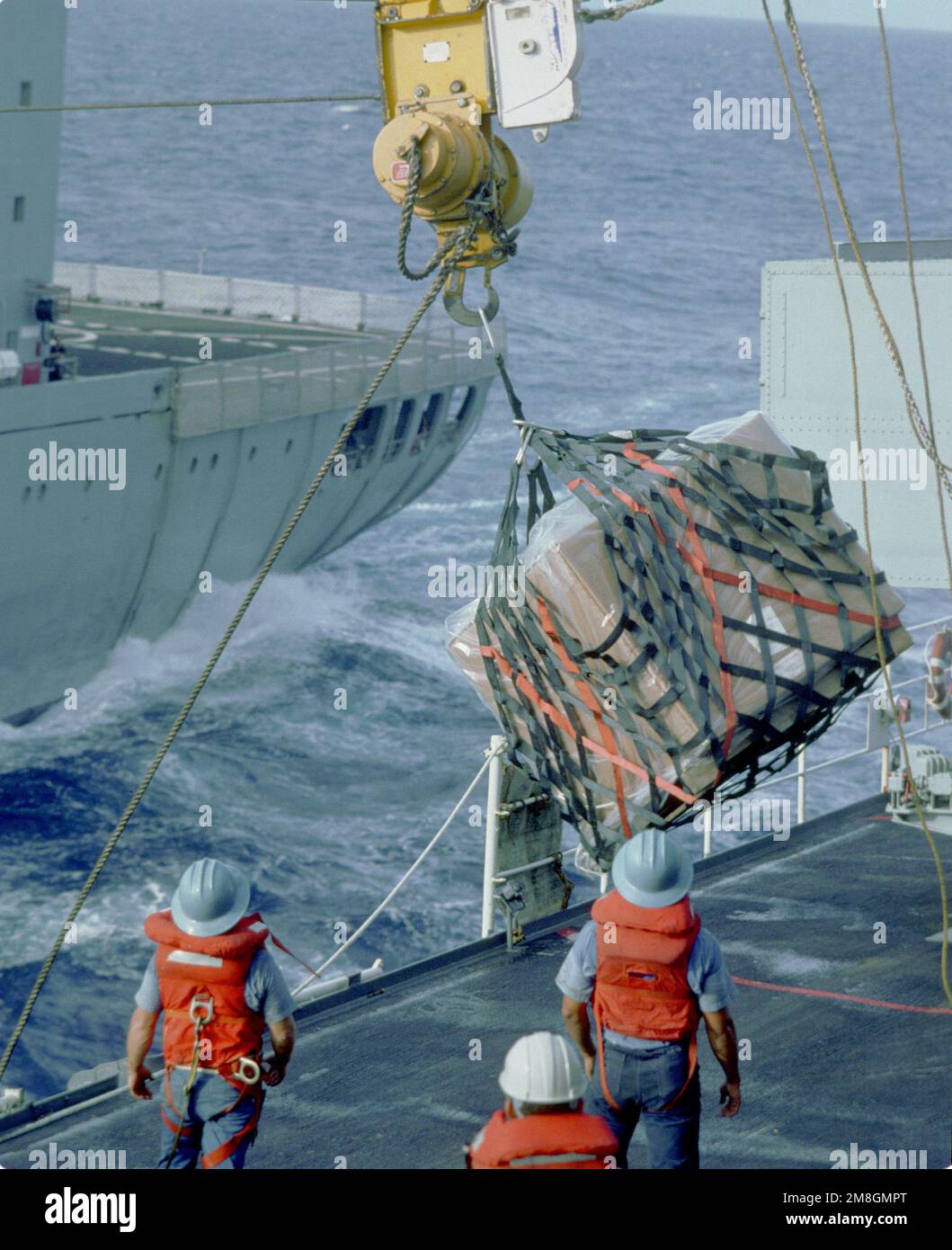 Crewman aboard the amphibious command ship USS BLUE RIDGE (LCC-19) wait ...