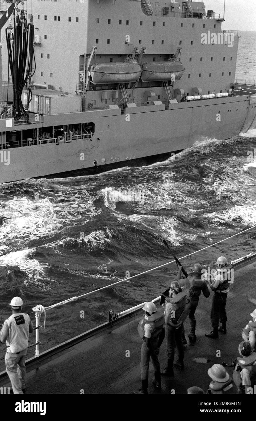 A crew member prepares to fire an M-14 rifle equipped with a line ...
