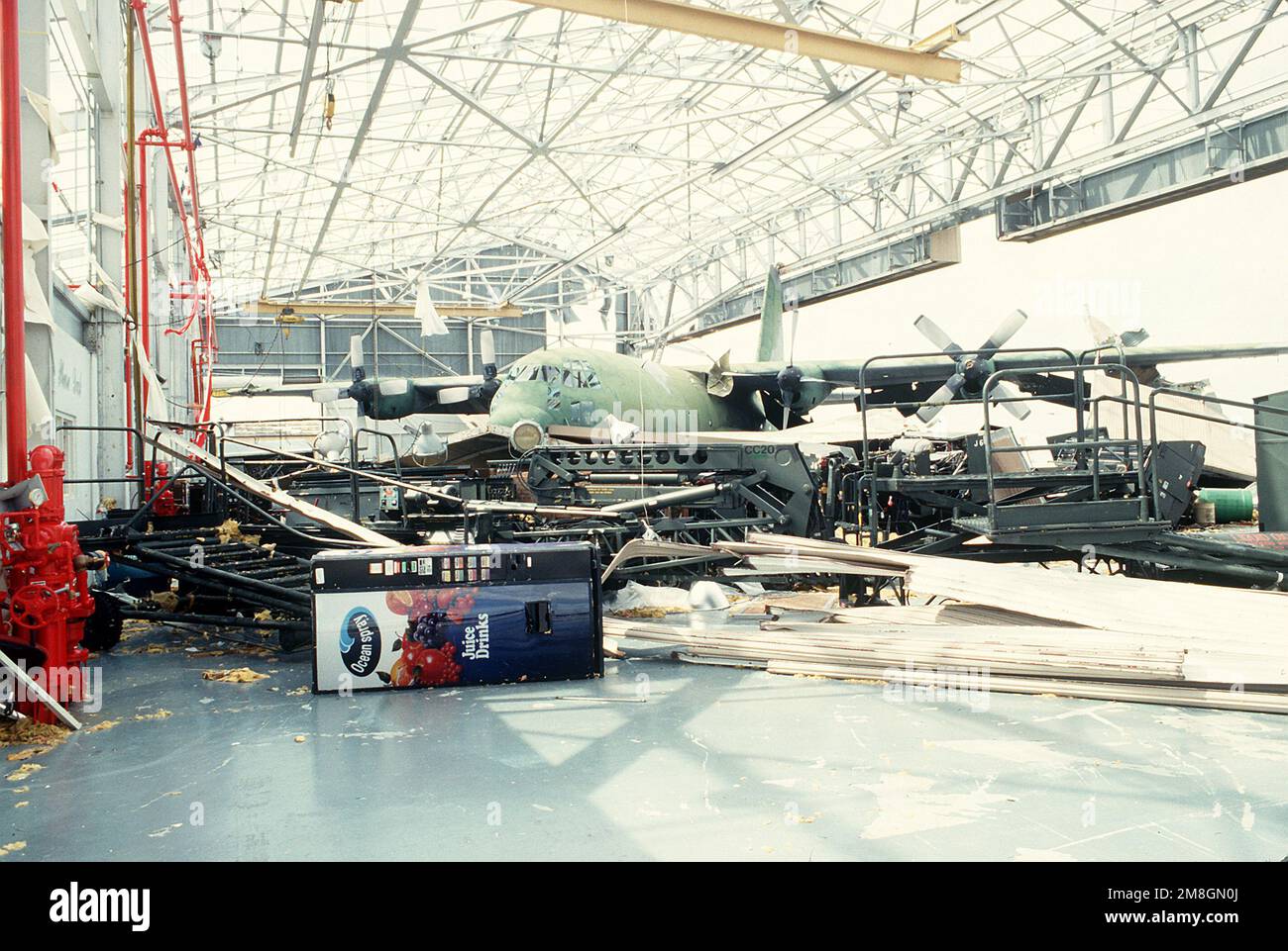 An AC-130 Hercules aircraft stands in a damaged hangar in the aftermath ...