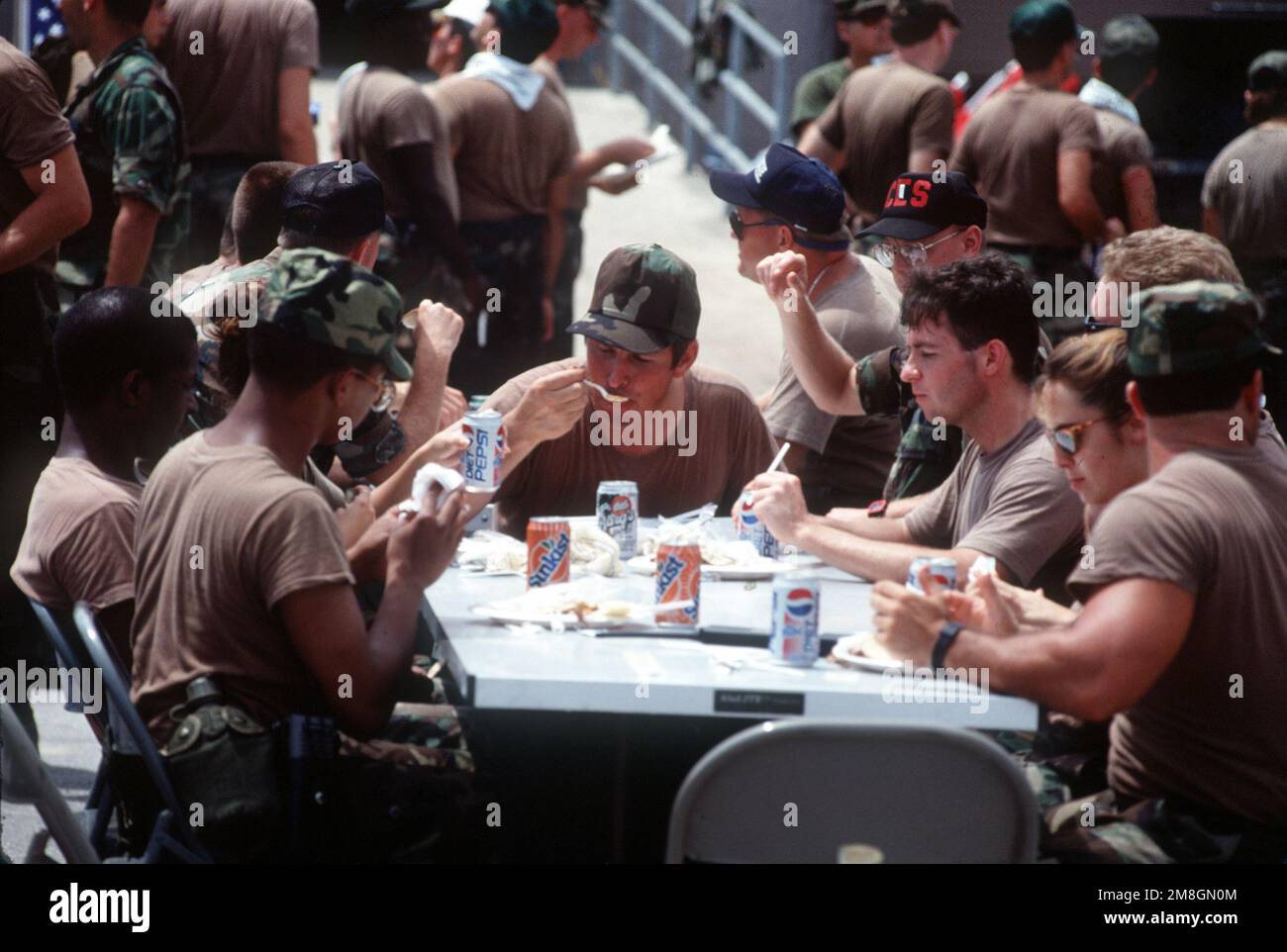 Relief workers and base personnel eat lunch in the base exchange ...
