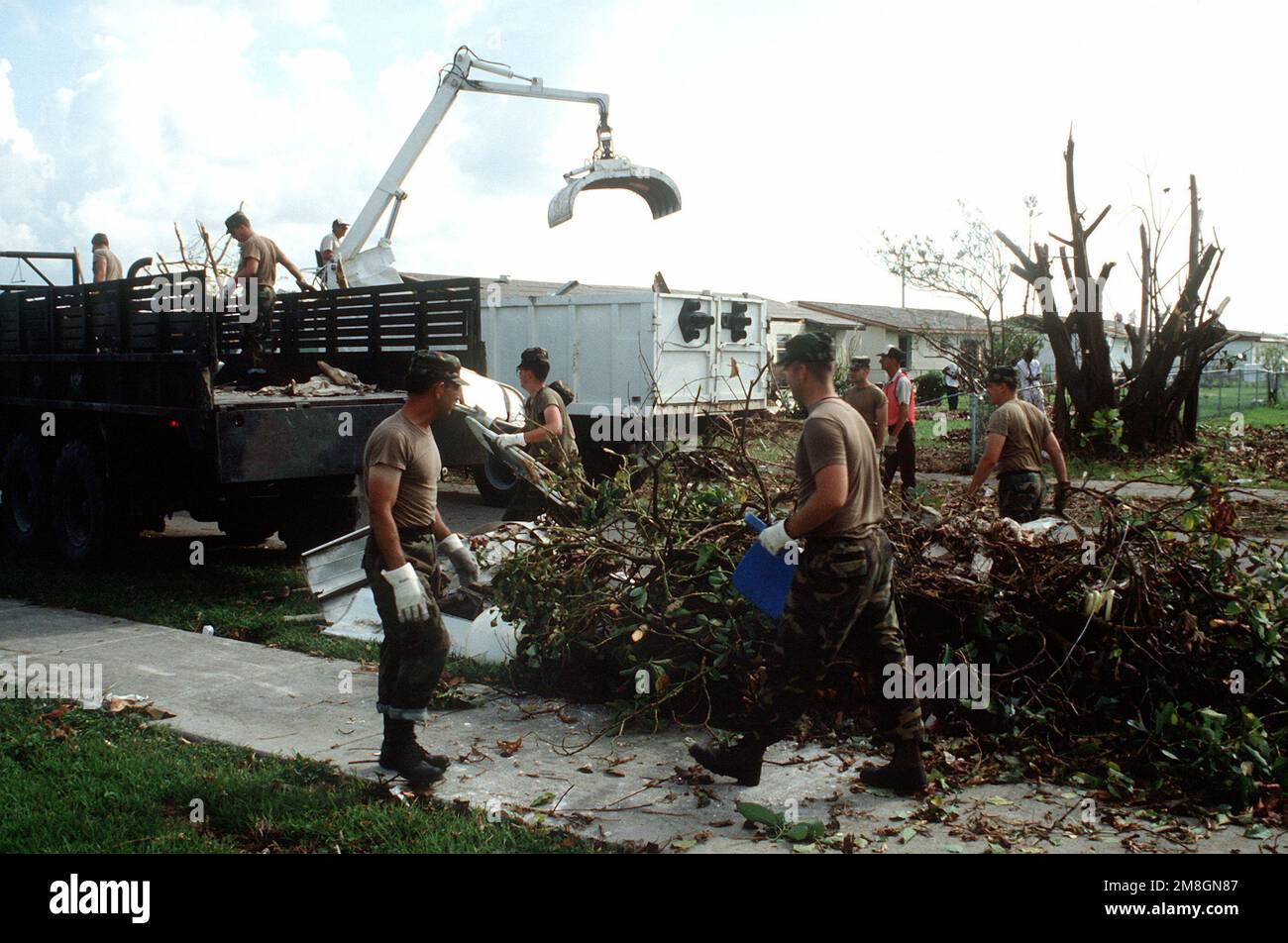 National Guardsmen clean up debris in the aftermath of Hurricane Andrew ...