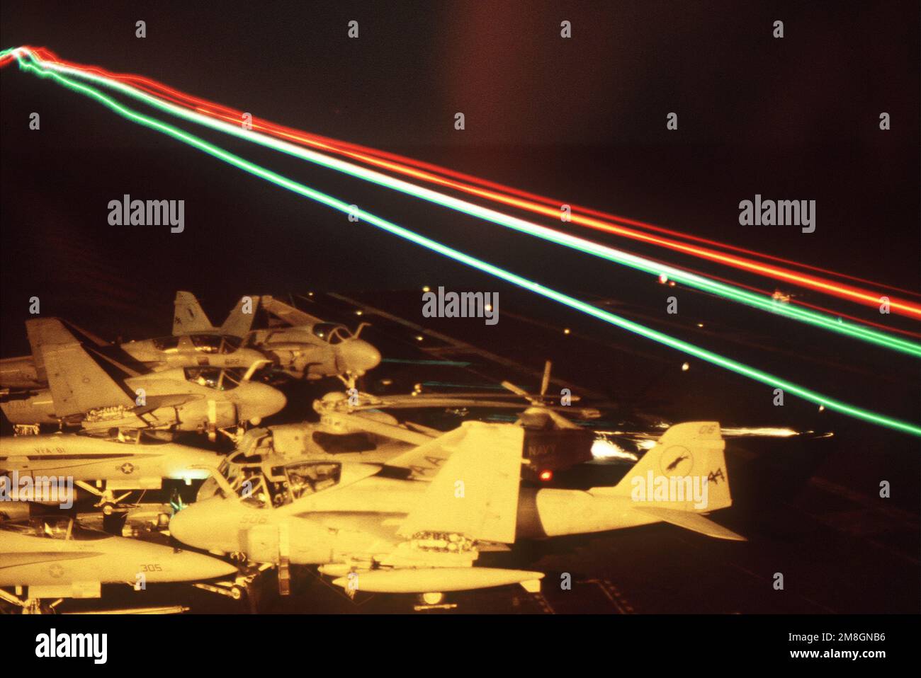 The running lights mark the path of an aircraft landing at night on the ...