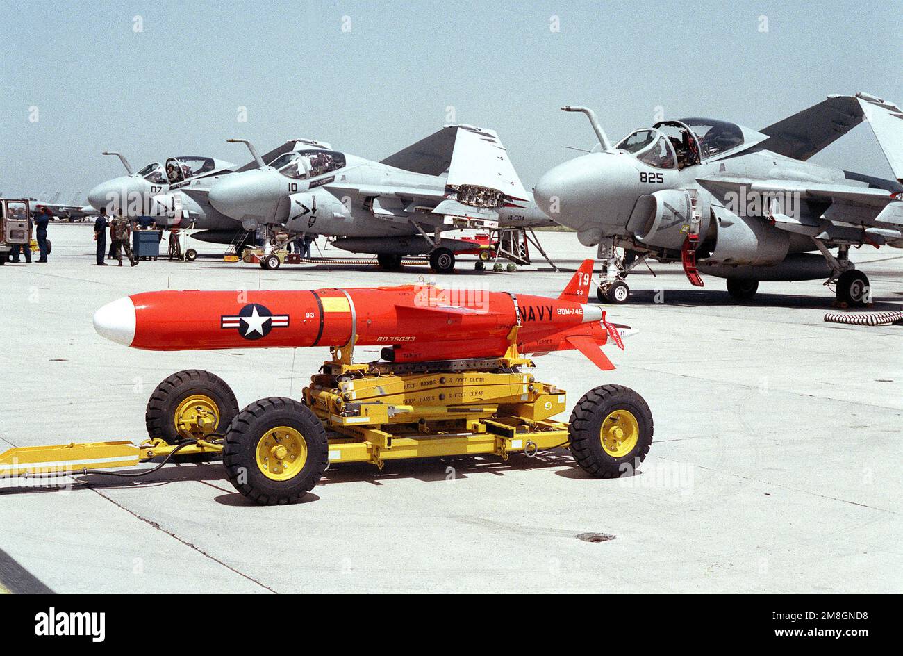 A left side view of a BQM-74E target drone strapped to a weapons loader ...