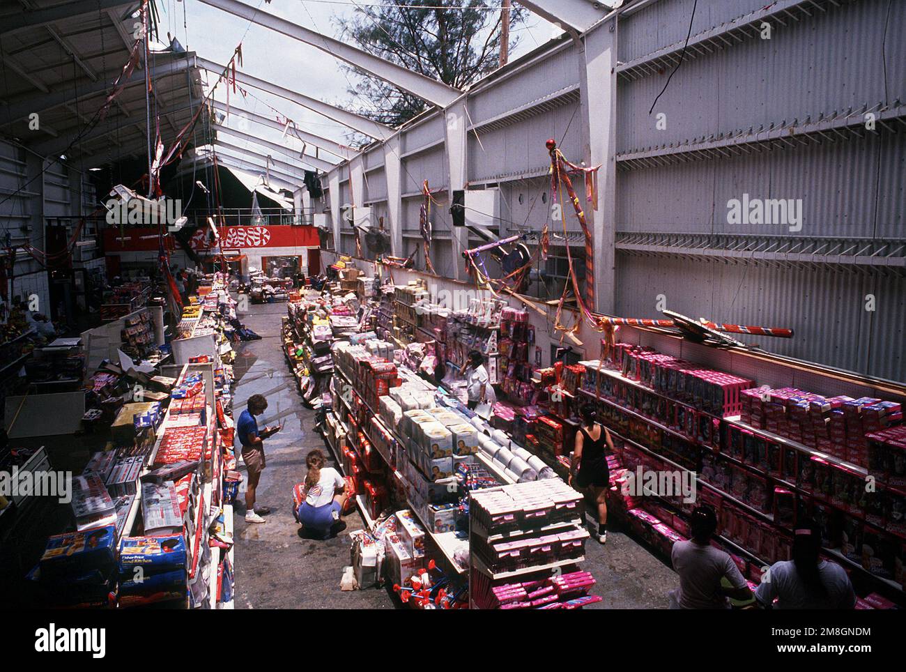 Workers take stock of the items lost when Typhoon Omar ripped the roof ...